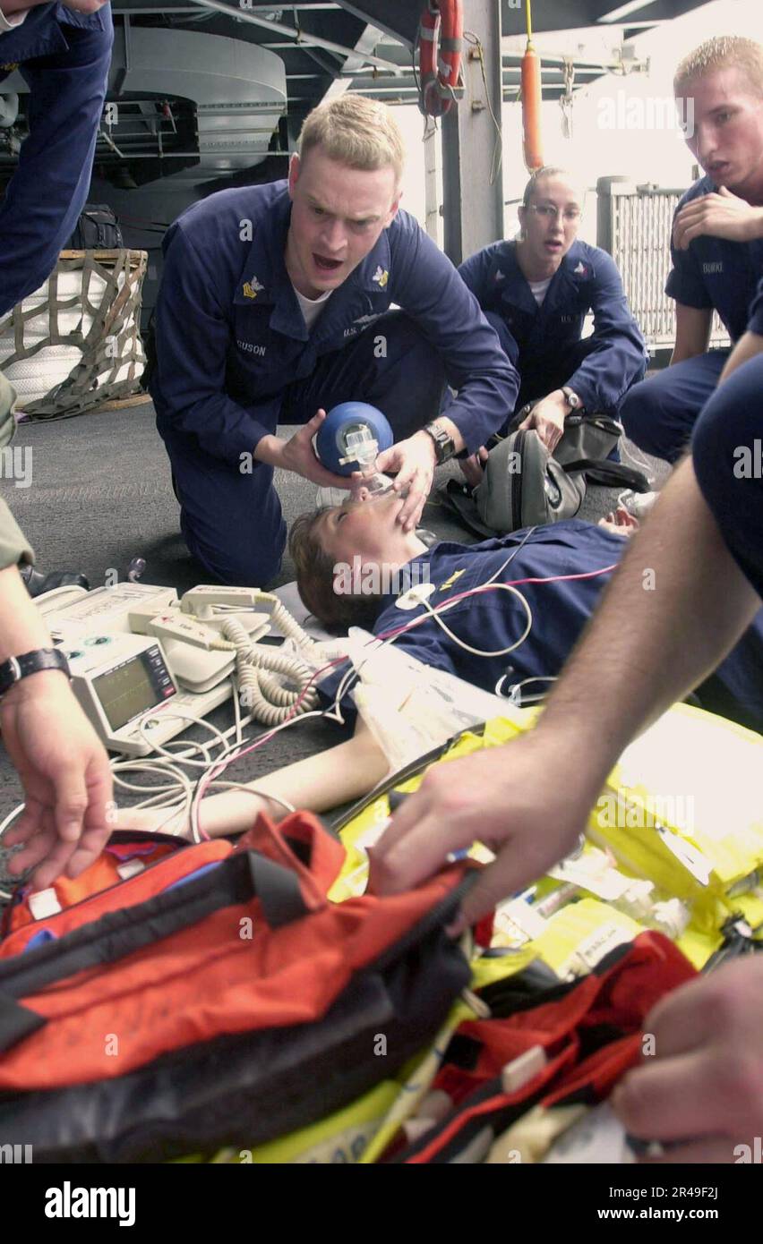 US Navy Hospital Corpsman 1st Class calls for a relief while performing ...