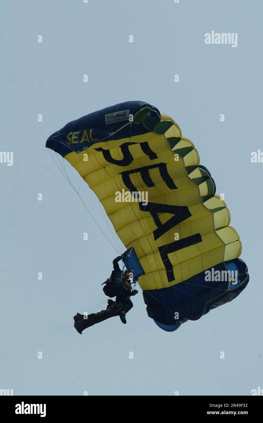US Navy A member of the Navy parachute team sails across the sky Stock ...