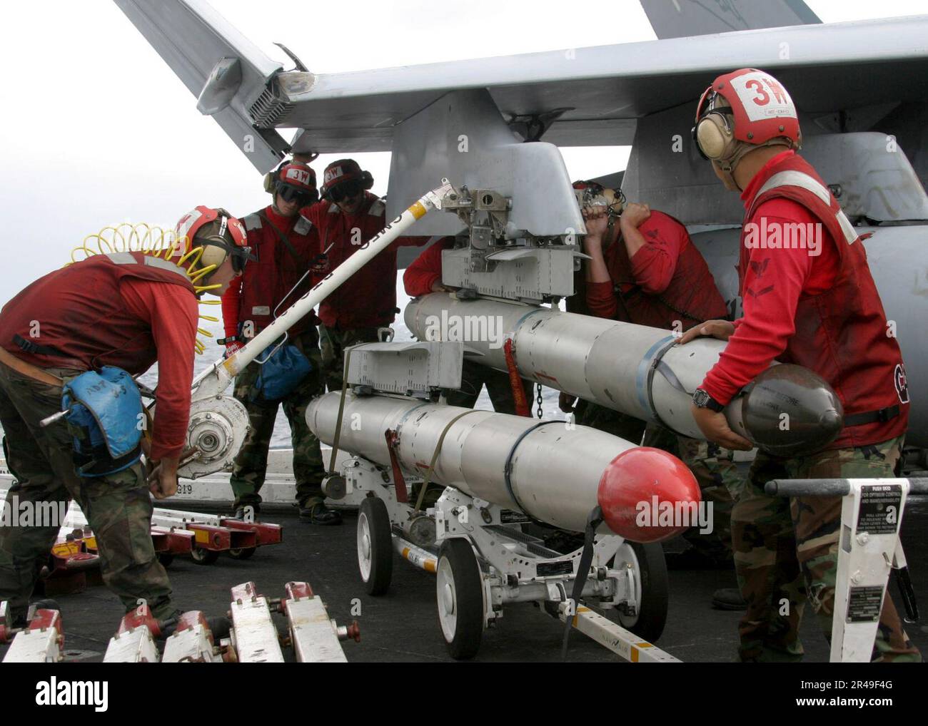 US Navy Weapons handlers, assigned to the Valions of Strike Fighter ...