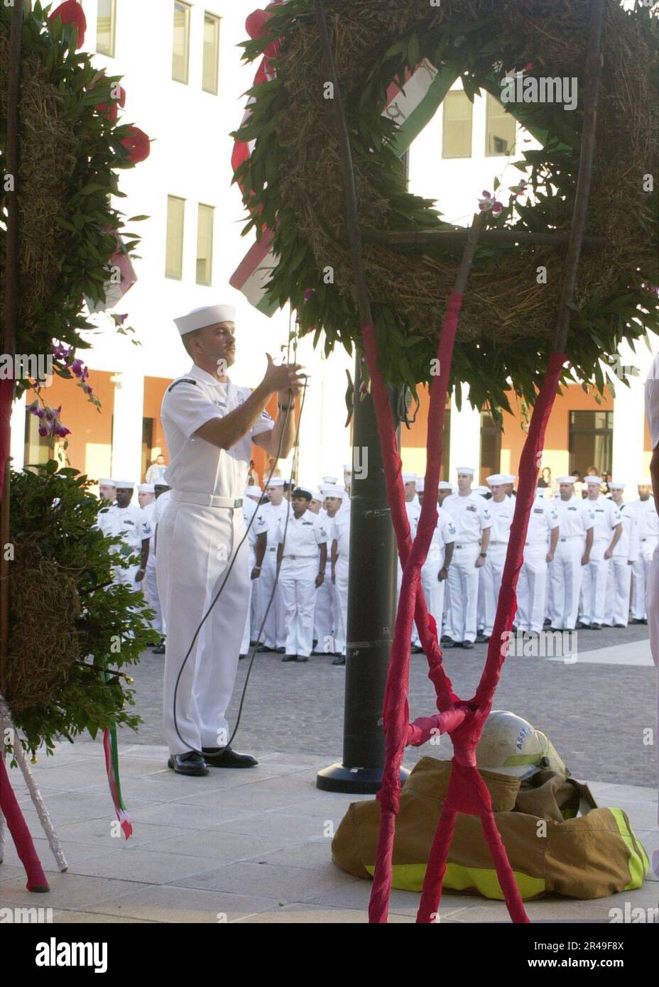 US Navy Builder 1st Class raises the American flag for morning colors ...