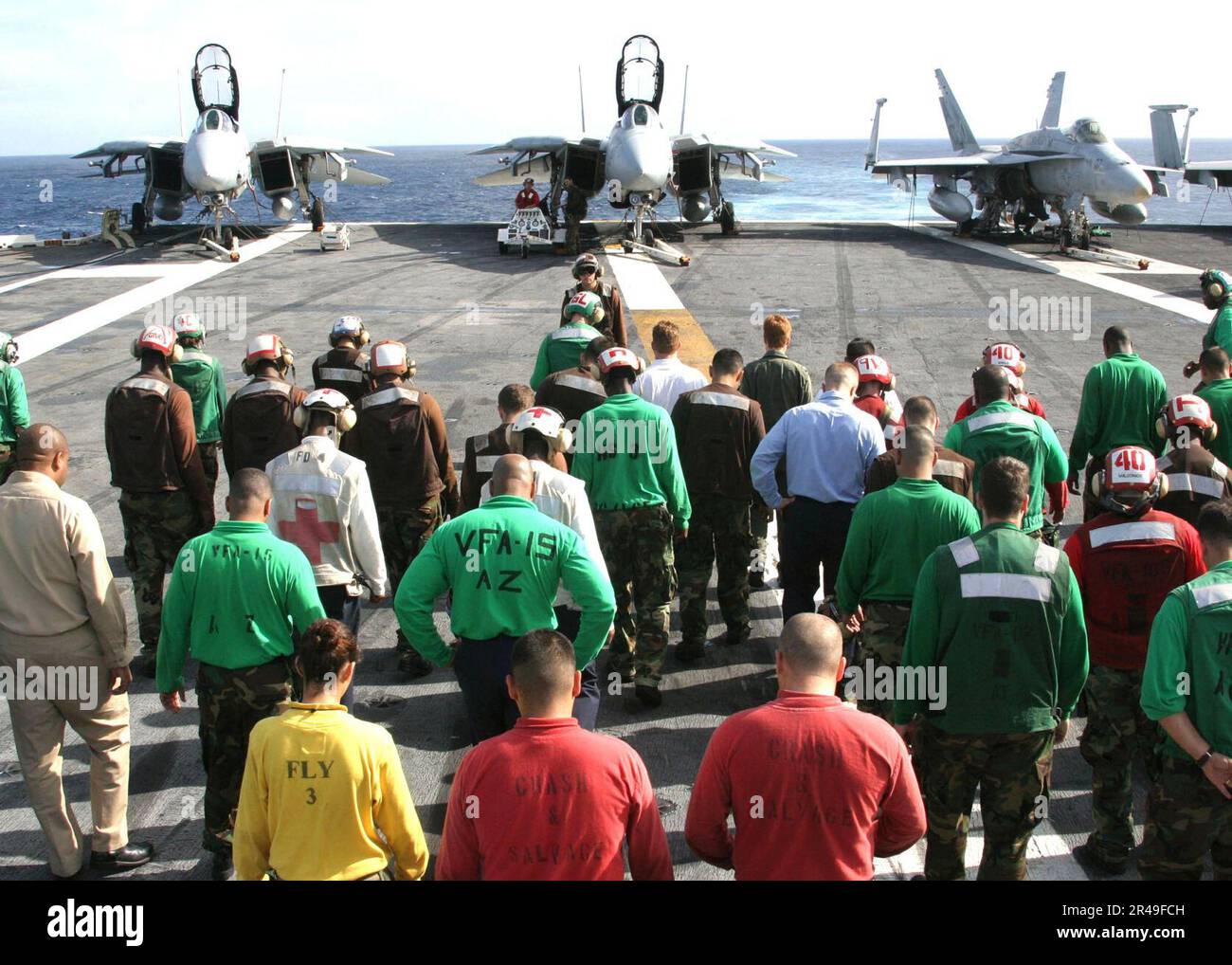 US Navy Crewmembers scour the flight deck during a Foreign Object ...