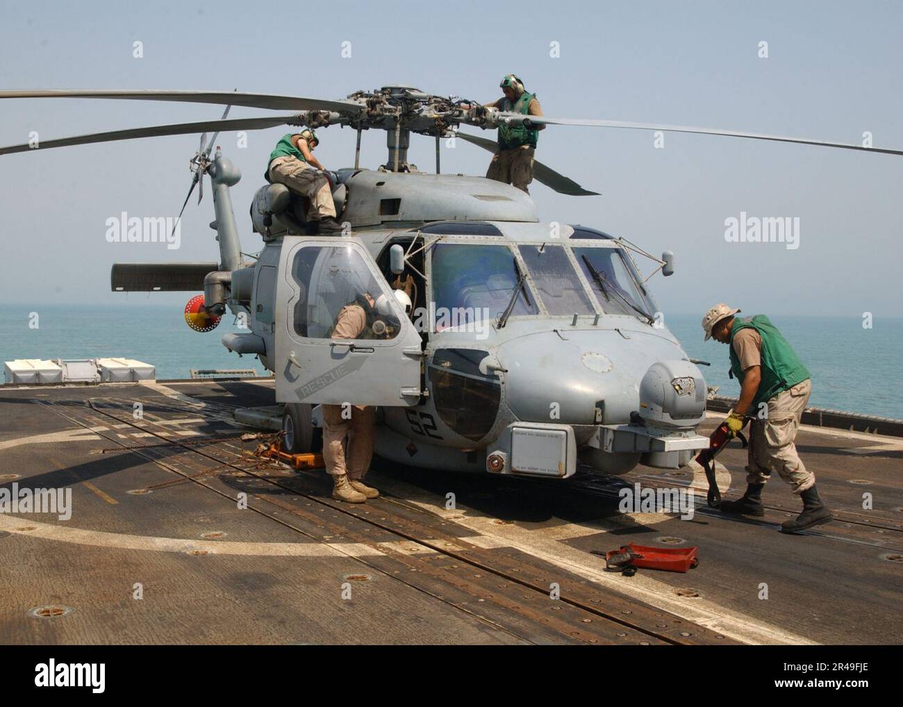 US Navy Crewmembers aboard USS Fletcher (DD 992) conduct maintenance on ...