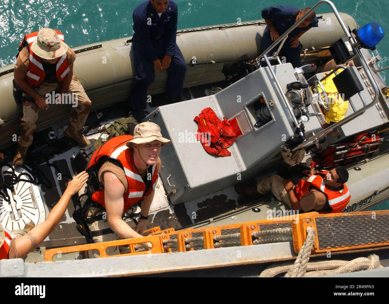US Navy Members of a USS Fletcher (DD 992) boarding team climb into a ...