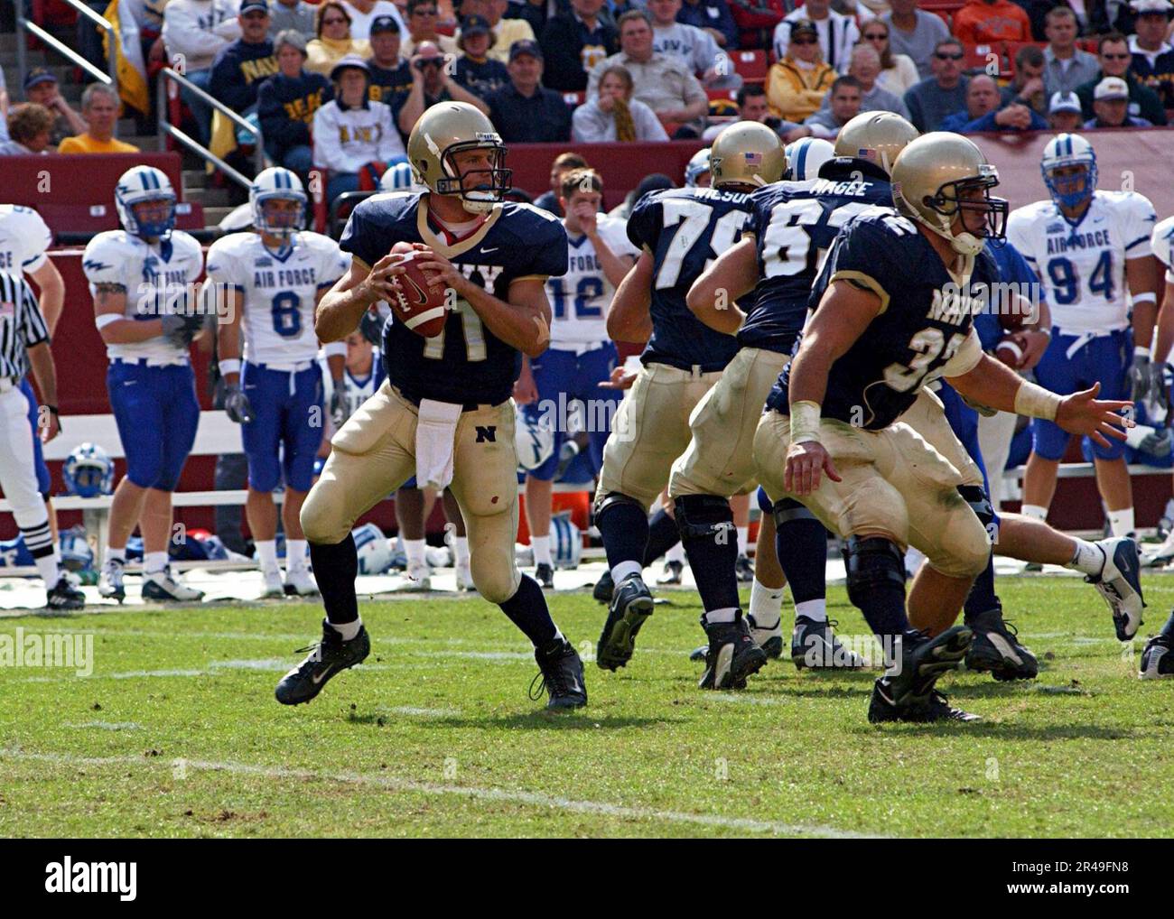 US Navy Navy quarterback Craig Candeto looks for a receiver down field ...