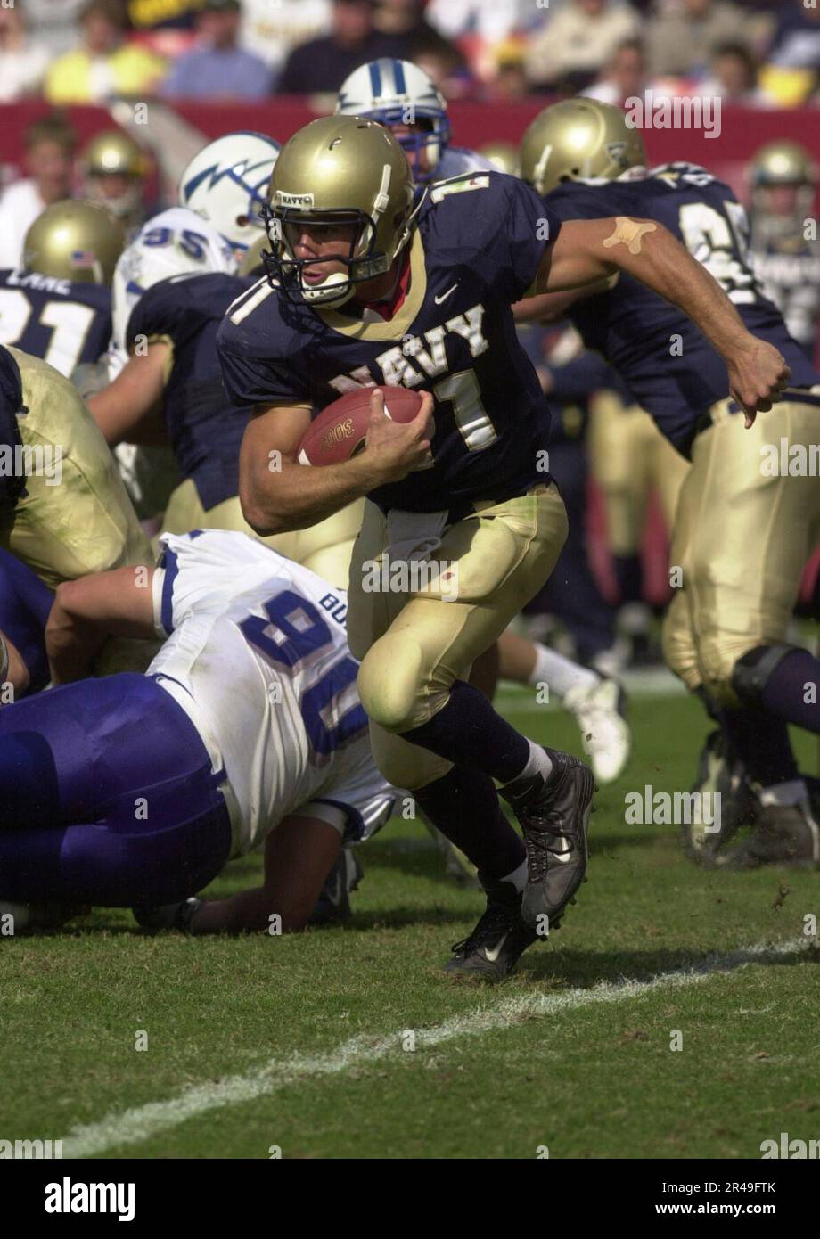 US Navy Navy senior quarterback Craig Candeto looks for a hole in the ...