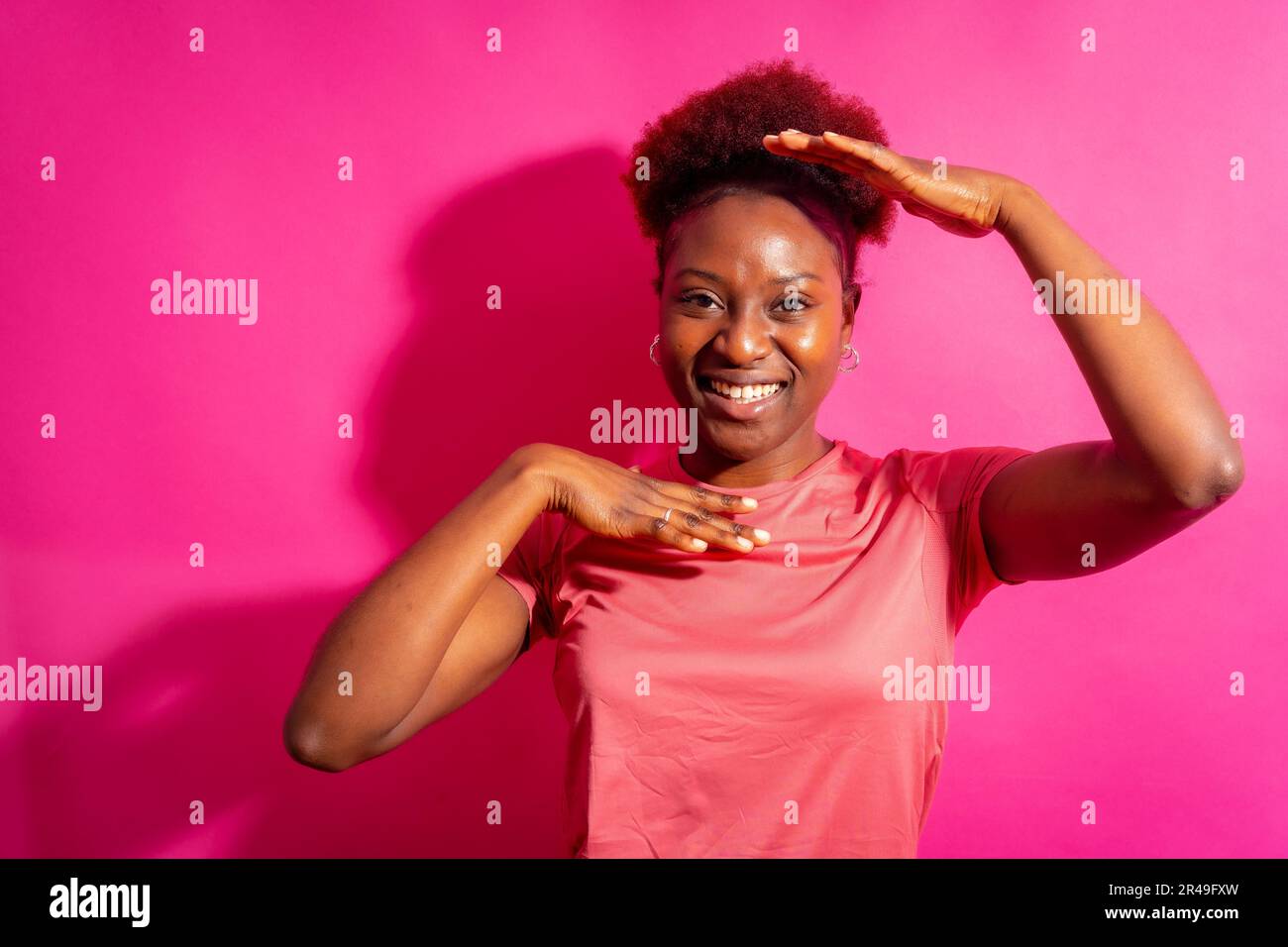 A portrait of a young cheerful black woman happily dancing Stock Photo ...