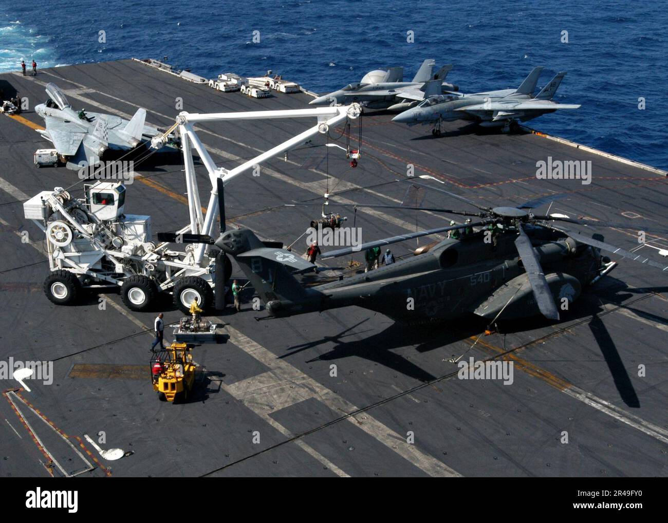US Navy Using the flight deck casualty crane, 'Tilly', the members of ...