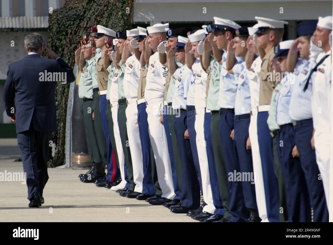 US Navy President George W. Bush returns the salute of Hawaii-based ...