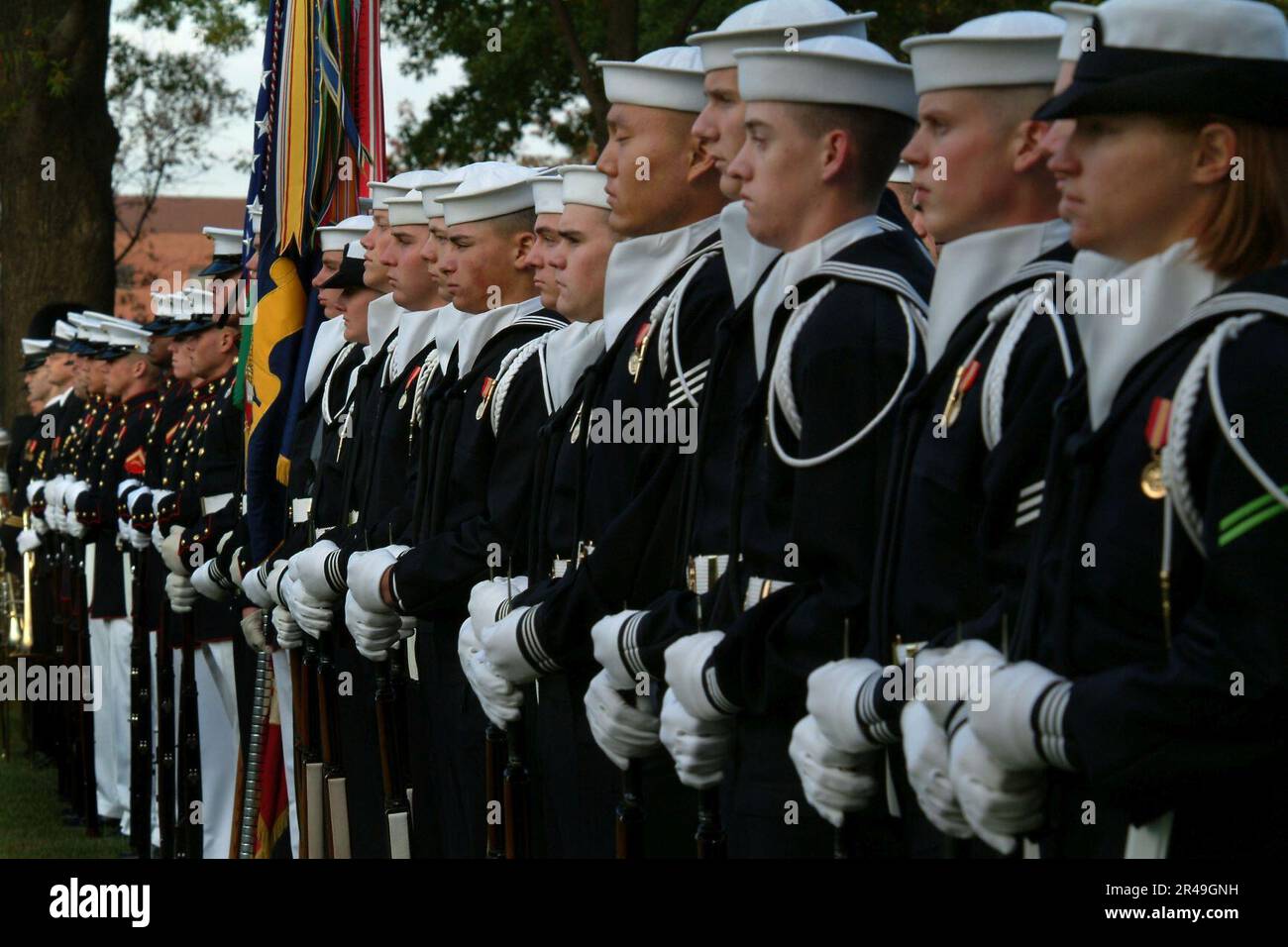 US Navy Sailors and Marines assigned to the U.S. Navy's Ceremonial Guard stand at attention ...