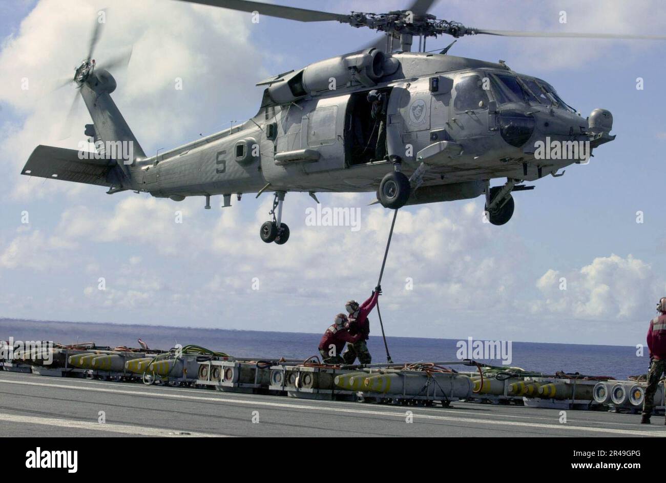 US Navy Ordnancemen assigned to USS Nimitz (CVN 68) gather ordnance for ...