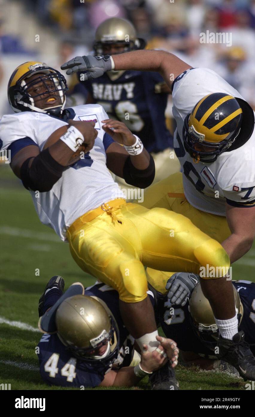 US Navy Delaware senior running back Antwan Jenkins is pulled down by ...