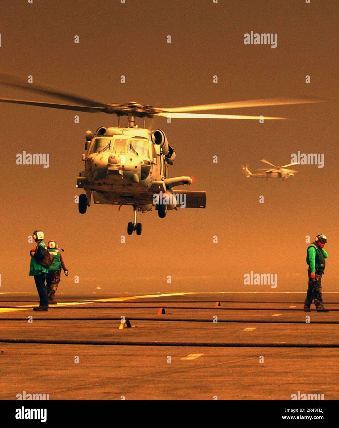 US Navy An HH-60H Seahawk takes off from the flight deck of USS John C. Stennis (CVN 74) as an ...