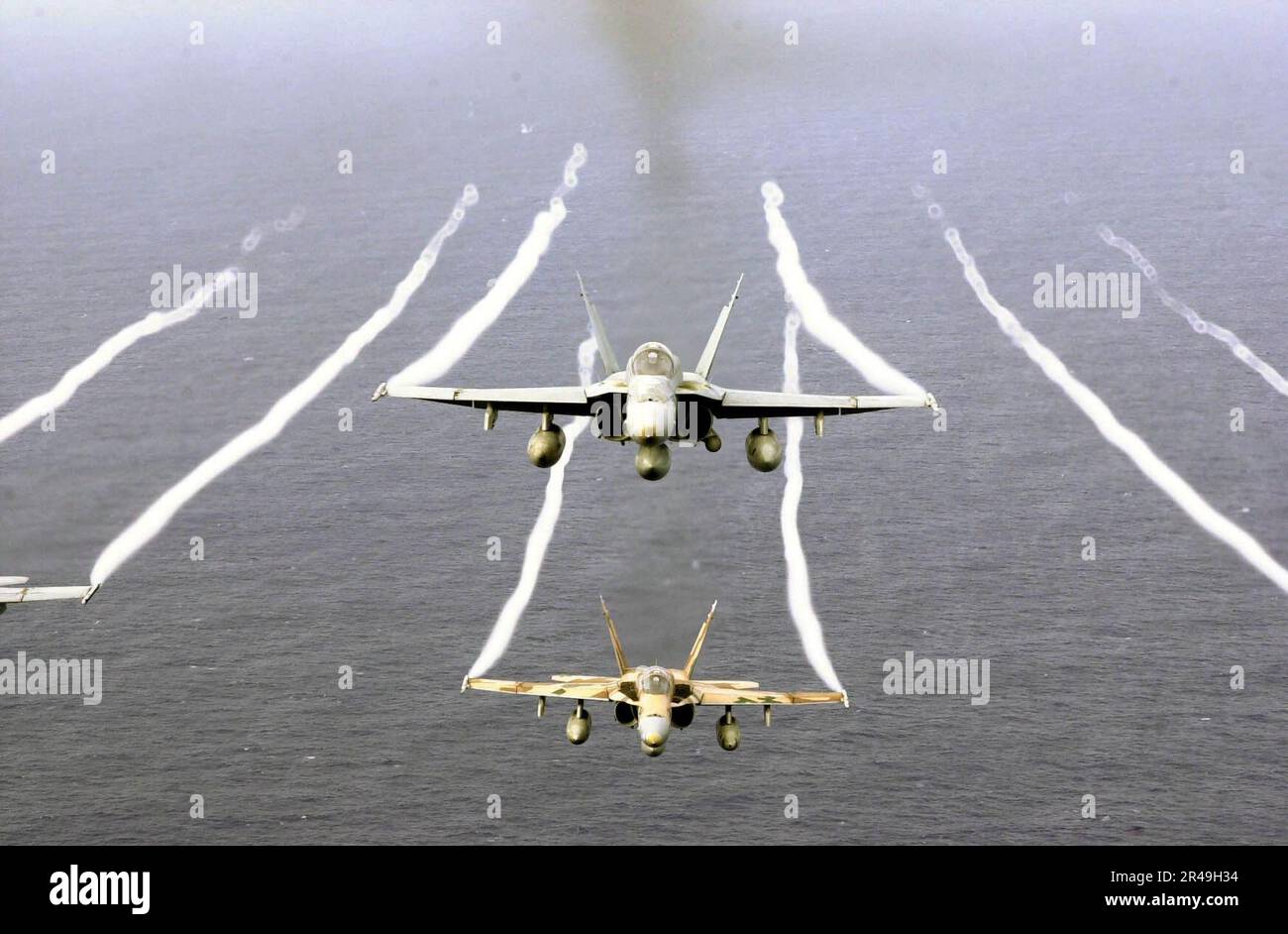 US Navy F-A-18A Hornets ly over the Western Pacific Ocean during flight ...