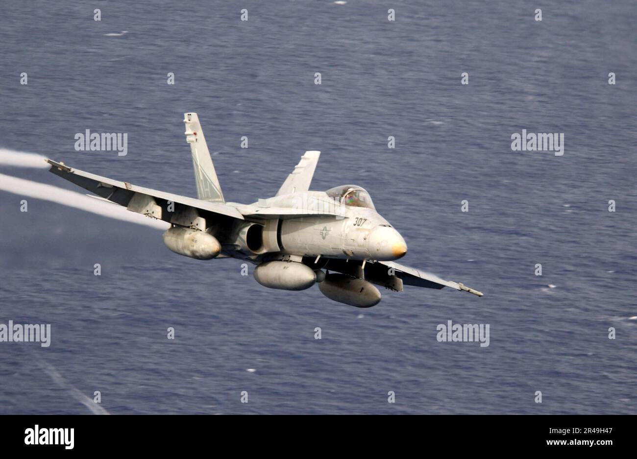 US Navy An F-A-18A Hornets fly over the Western Pacific Ocean during ...