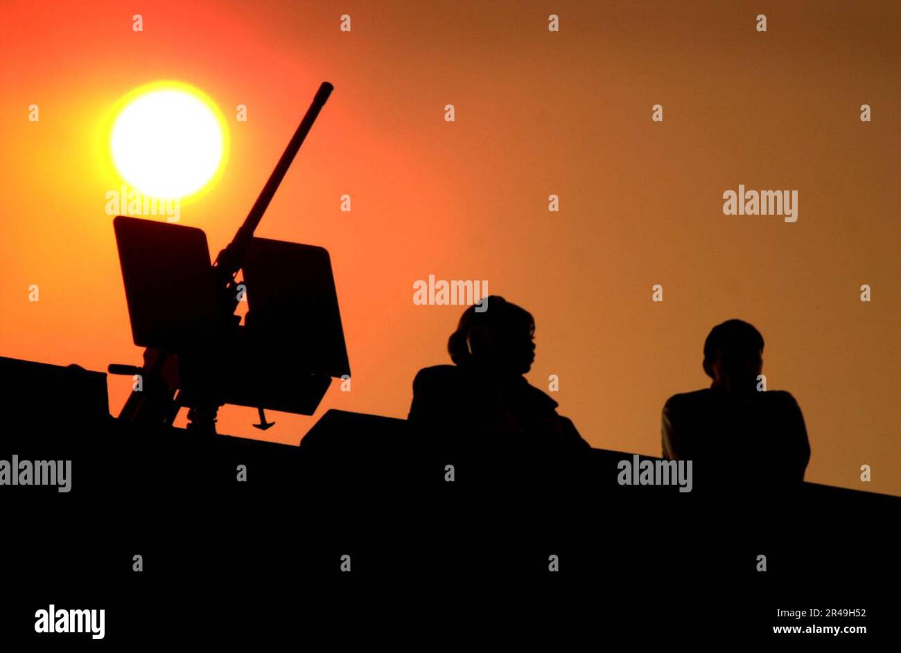 US Navy Weapons personnel aboard USS John C. Stennis (CVN 74) stand a ...