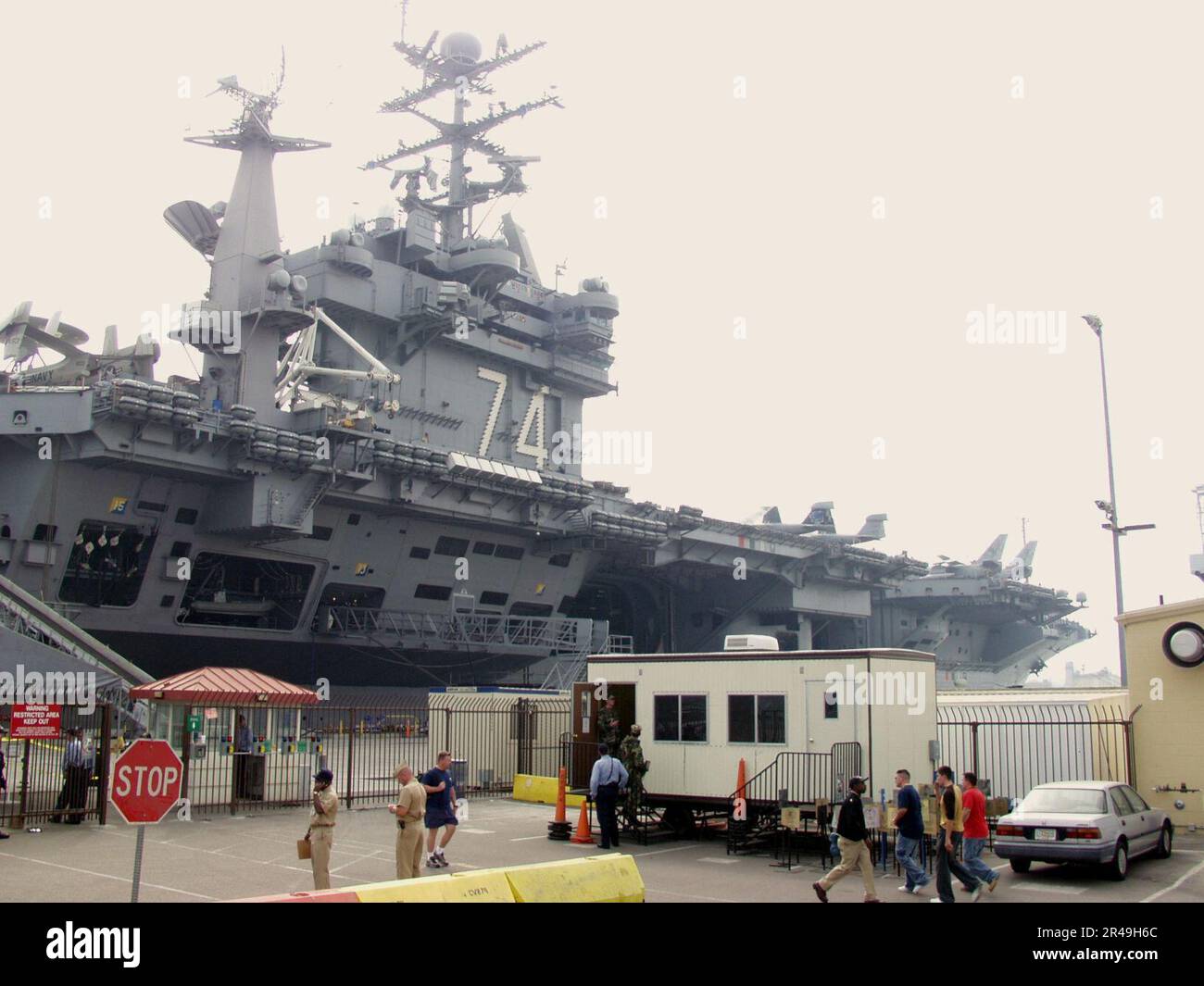 US Navy USS John C. Stennis (CVN 74) is moored pier side under a cloud ...