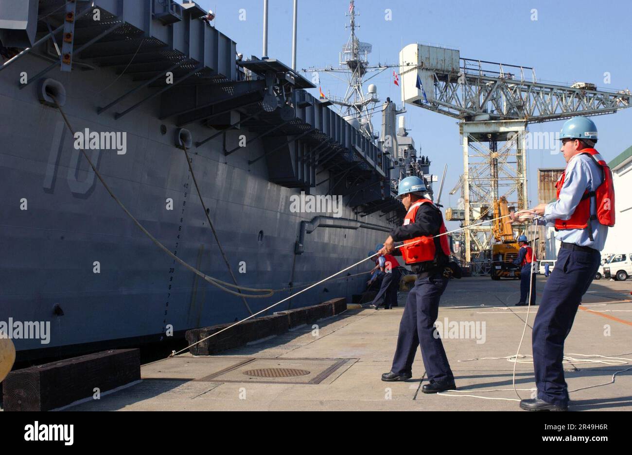 US Navy Sailors assigned to U.S. Fleet Activities Sasebo assist in the ...