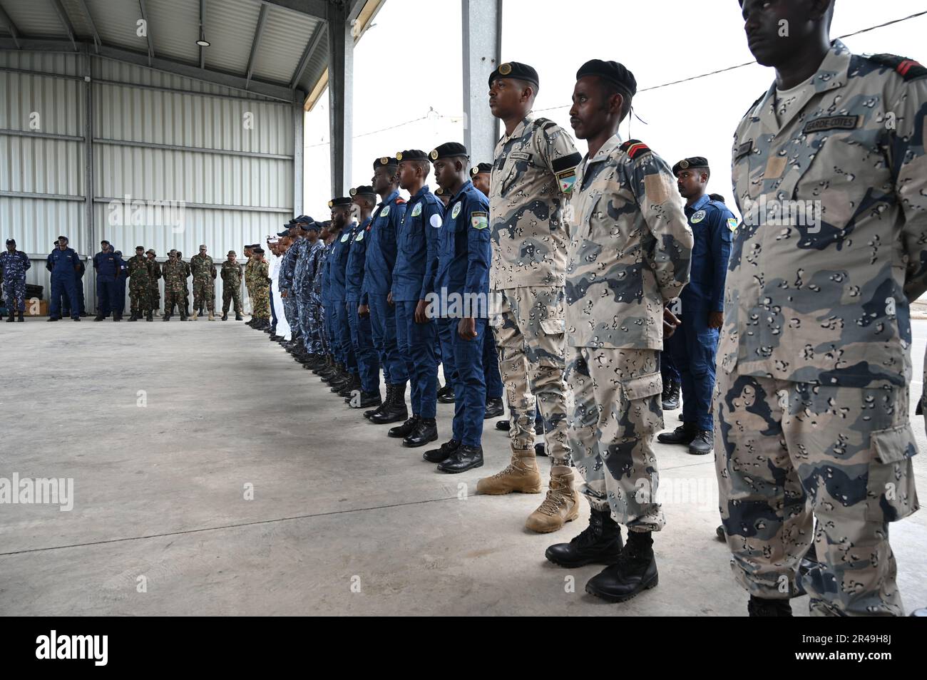 Service member from multiple countries stand at ease for the closing ...