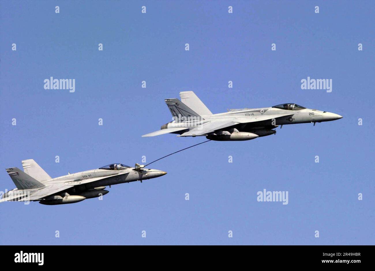 US Navy Two F-A-18 Hornets perform re-fueling maneuvers while passing ...