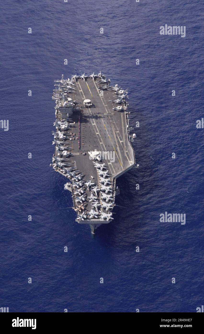 US Navy USS Nimitz (CVN 68) crewmembers participate in a flag unfurling ...