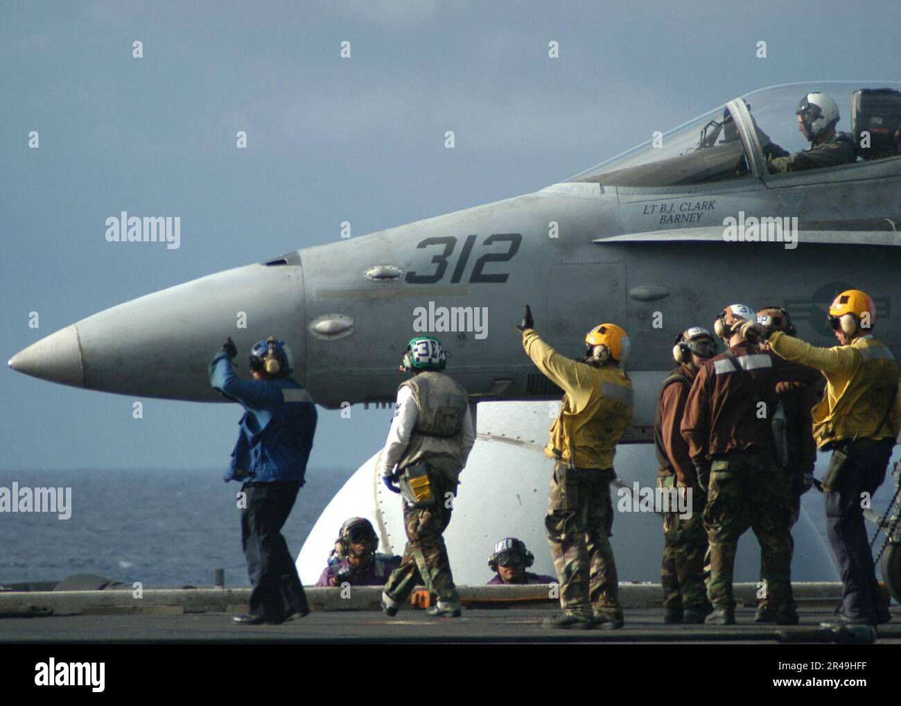 US Navy Flight deck crew ask members the arresting gear officer for ...