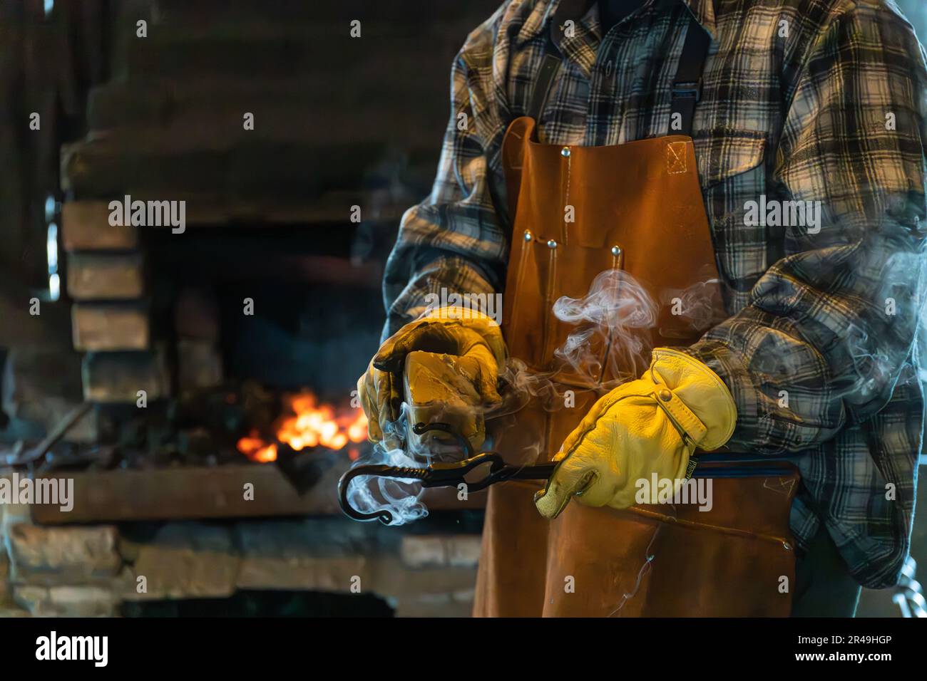 Blacksmith applying wax to a manually forged metal object Stock Photo ...