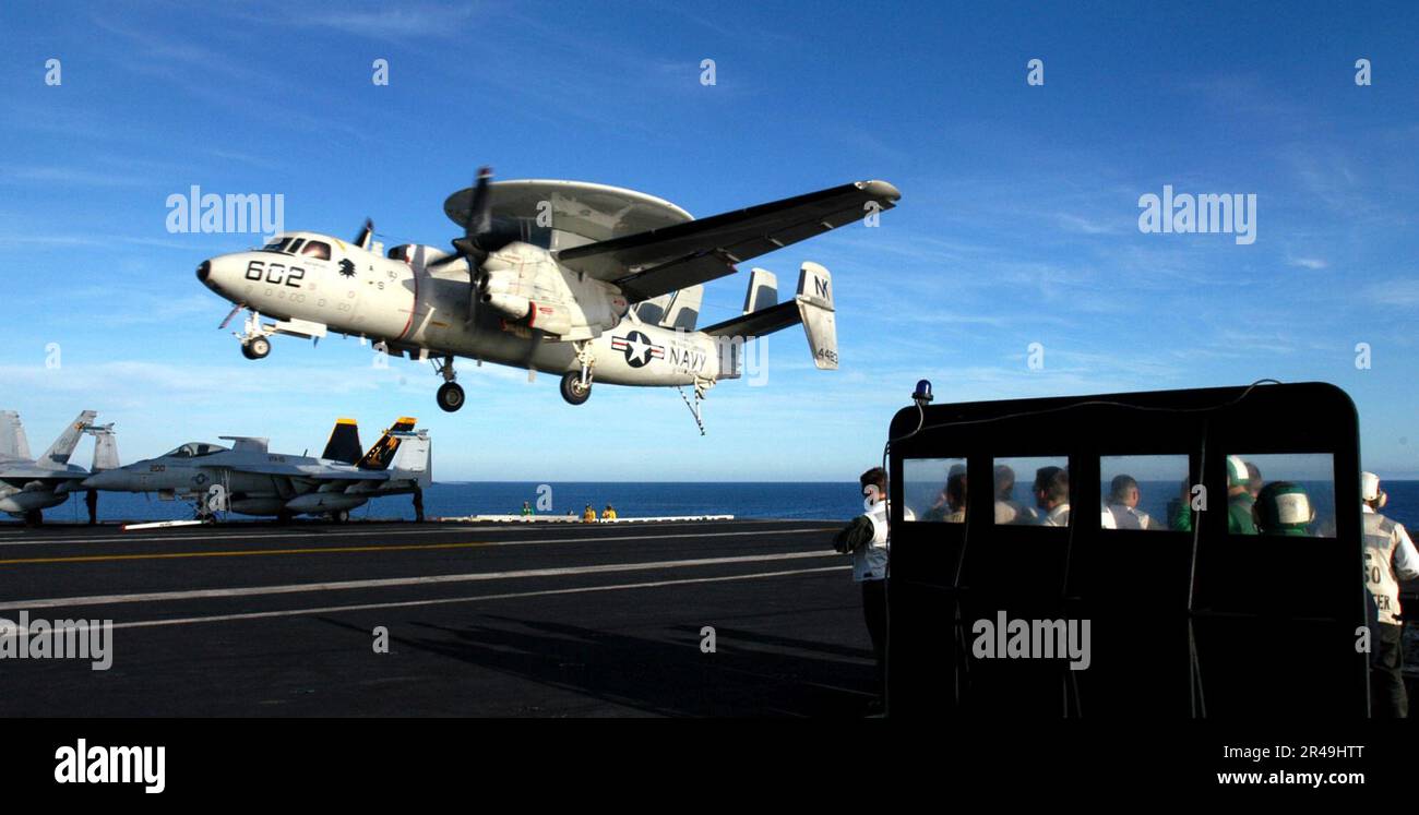 US Navy Landing Signal Officers guide an E-2C Hawkeye assigned to the ...