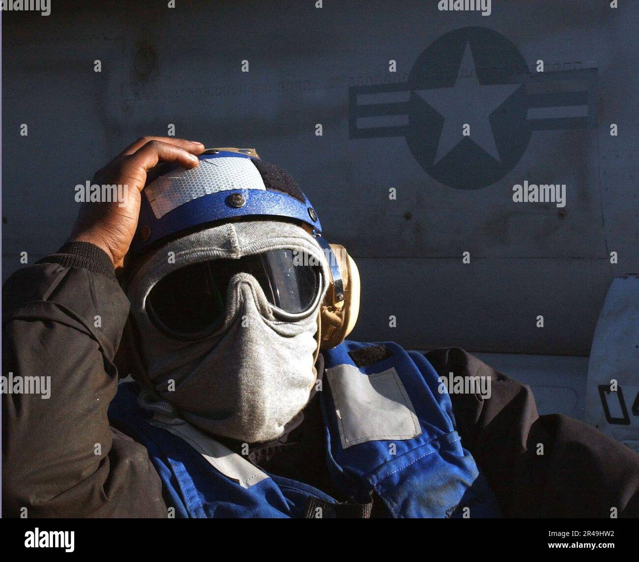 US Navy An Aviation Boatswain's Mate dons a face mask to diffuse ...