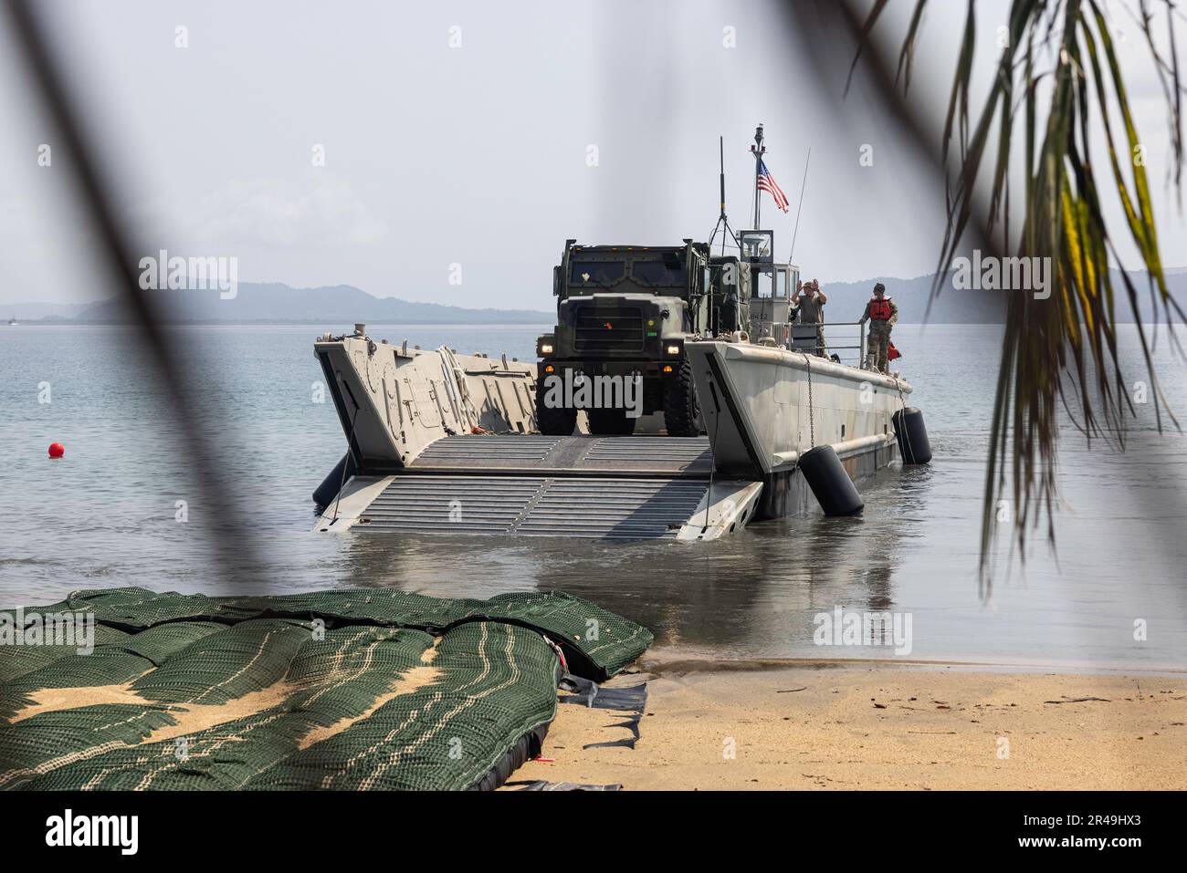 A U.S. Army Landing Craft Mechanized carries a Marine Medium Tactical ...