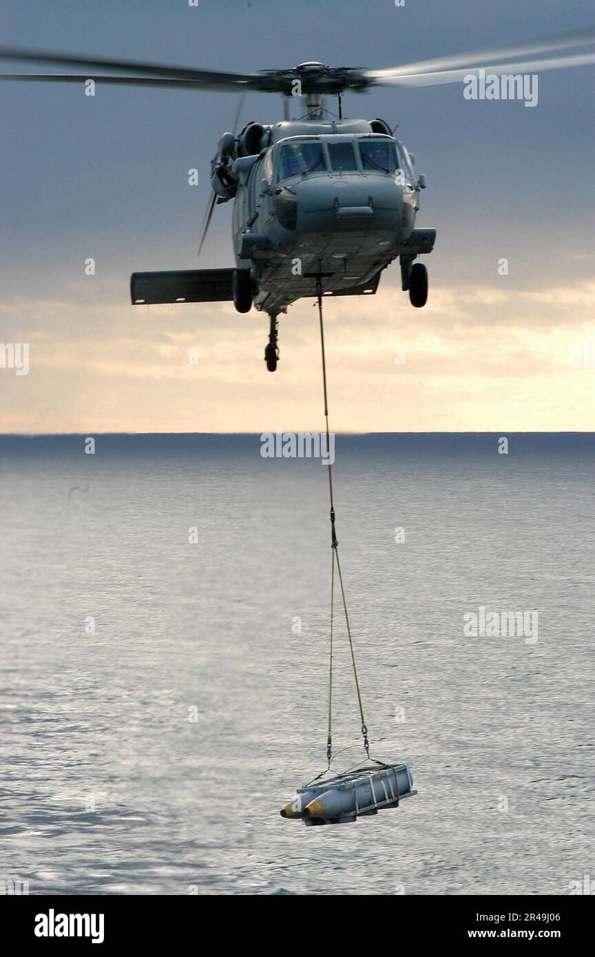 US Navy An MH-60S Knighthawk transports ordnance from the USNS Supply ...