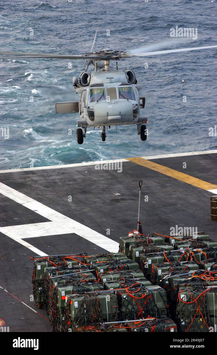US Navy An SH-60 Seahawk helicopter prepares to transport ordnance from ...