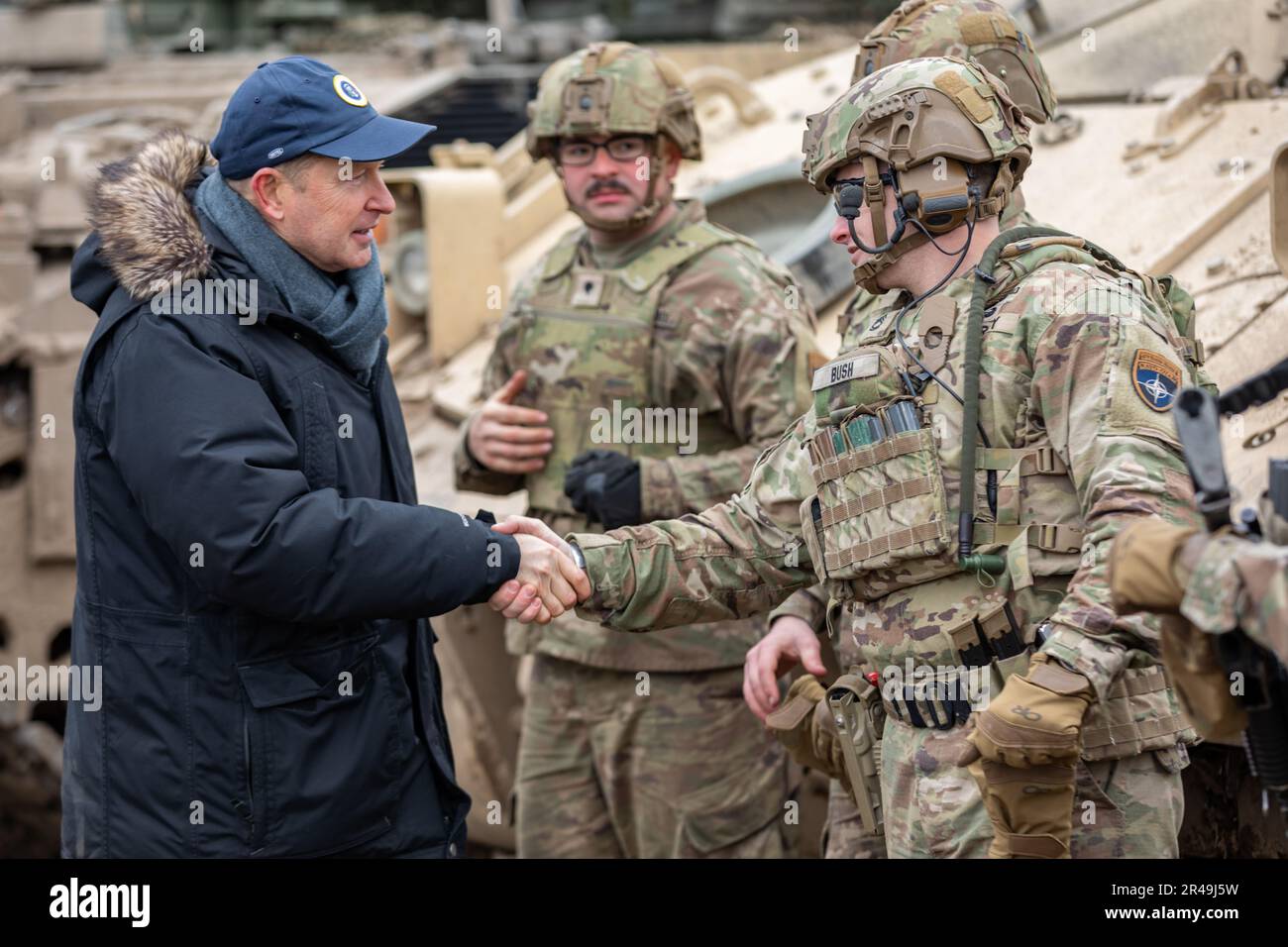 United States Ambassador to Poland, Mark Brzezinski, left, shakes hands ...