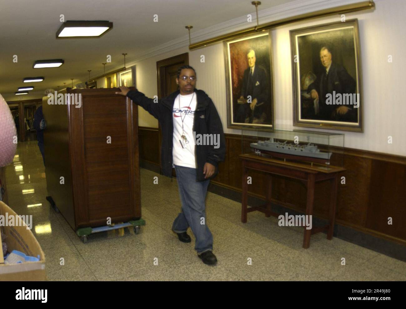 US Navy Office Mover employees roll the Under Secretary of the Navy's ...