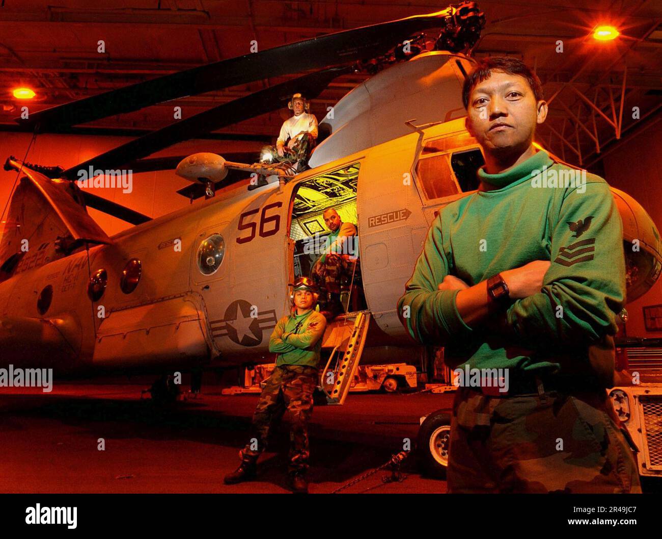 US Navy HC-11 squadron members pose for a photo infront of a CH-46D ...