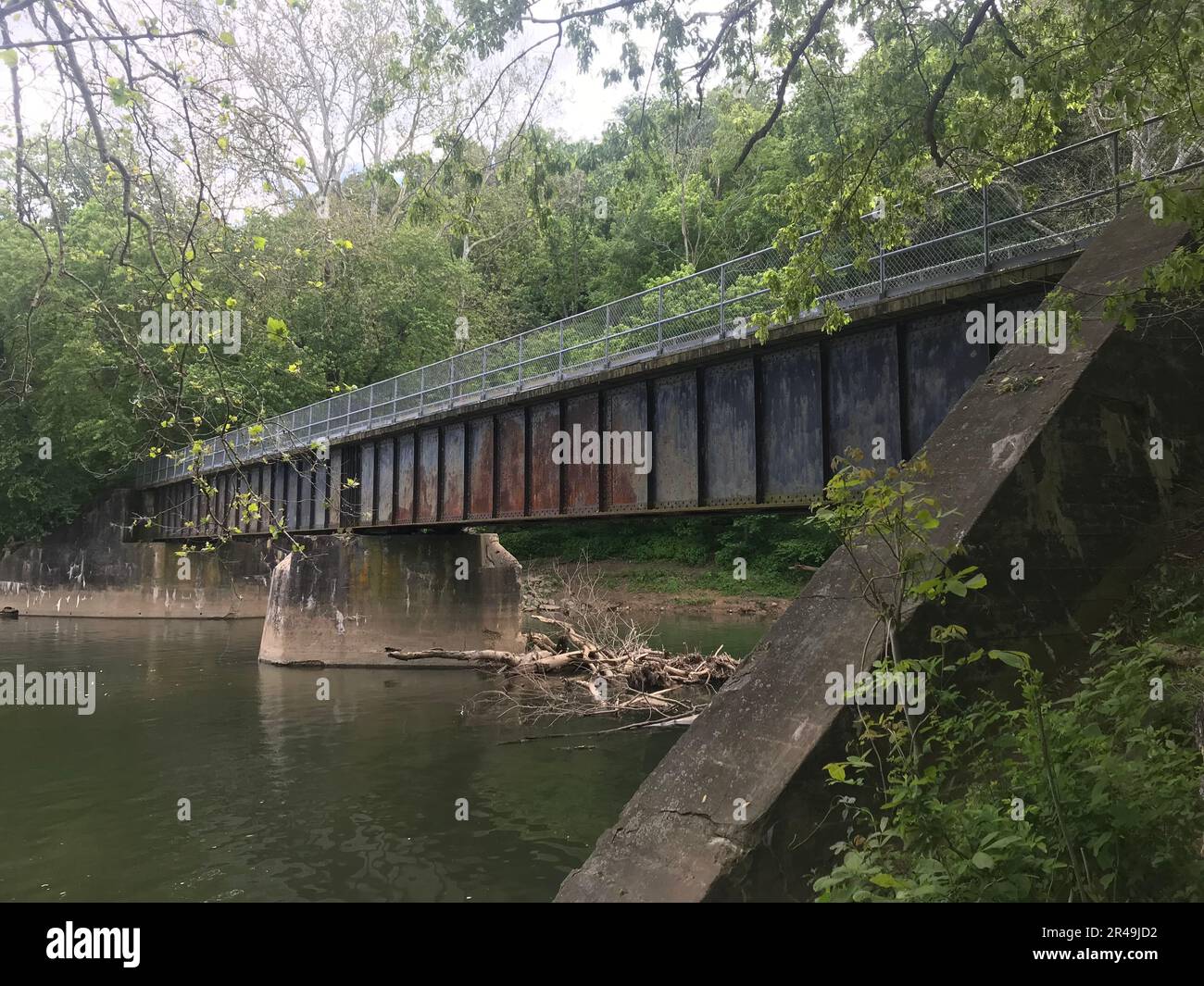 A rusty railway bridge spanning a vast expanse of landscape Stock Photo ...