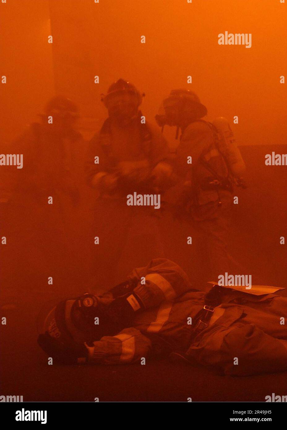 US Navy Fire party members discover a fallen shipmate during a ...