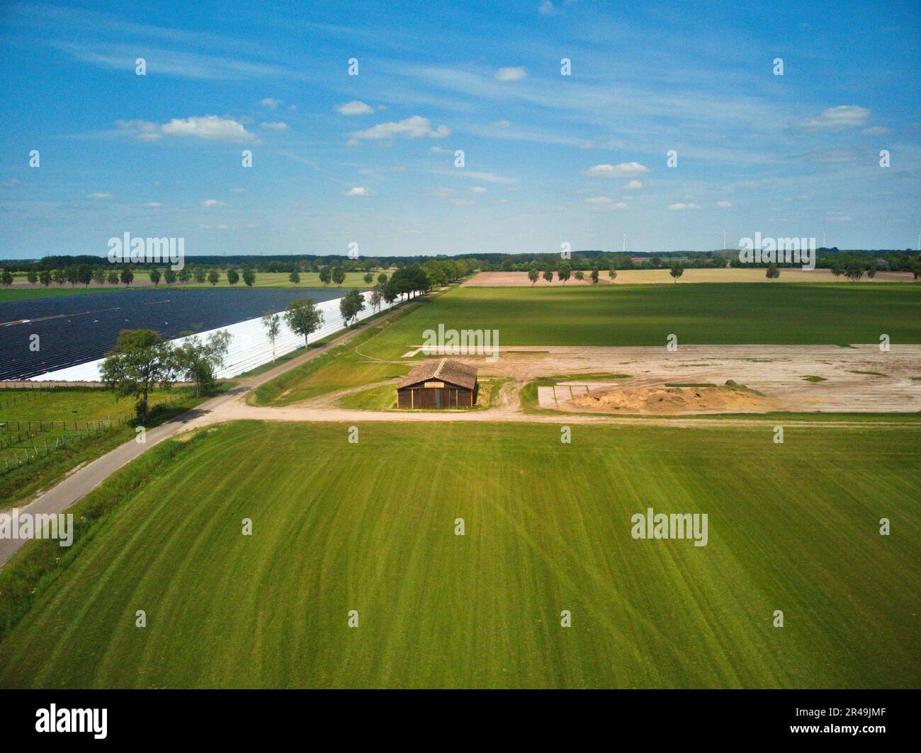 An aerial shot of a farm, taken from beyond the perimeter fence ...