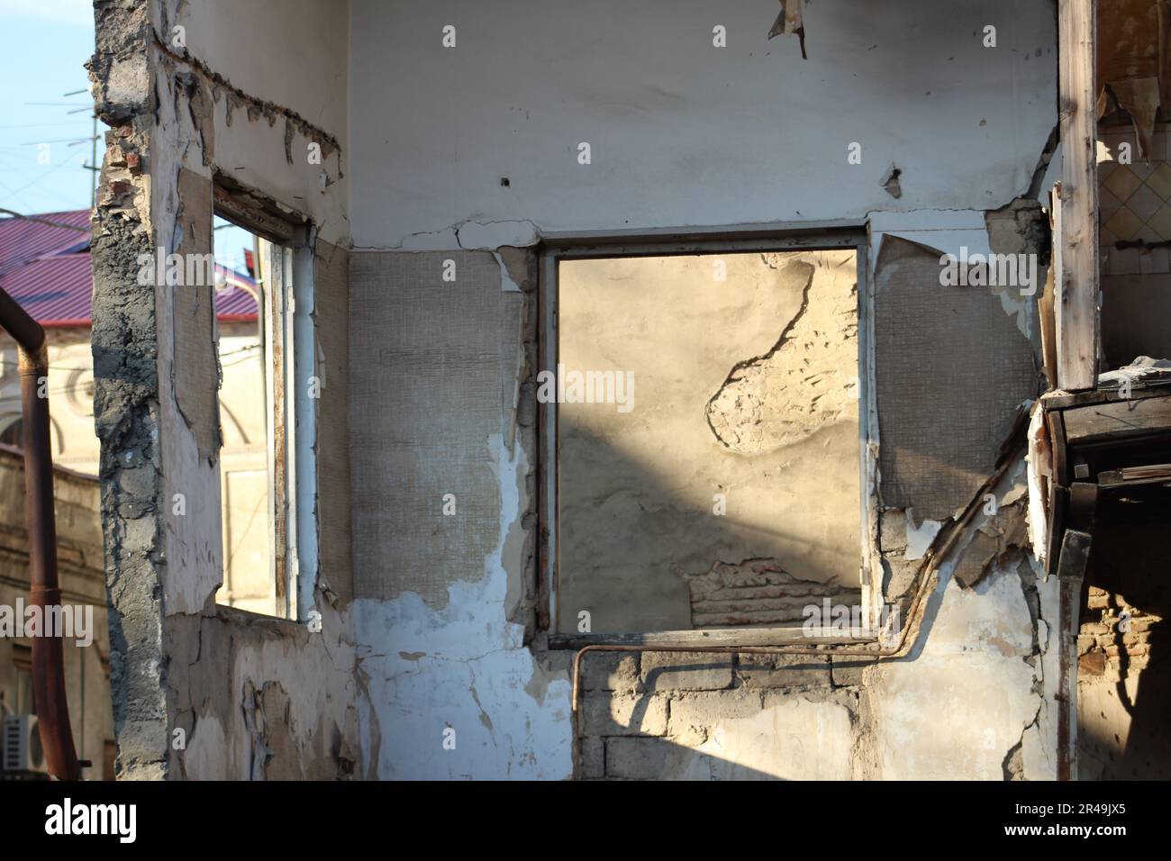 An old building with damaged walls in the sunlight Stock Photo - Alamy