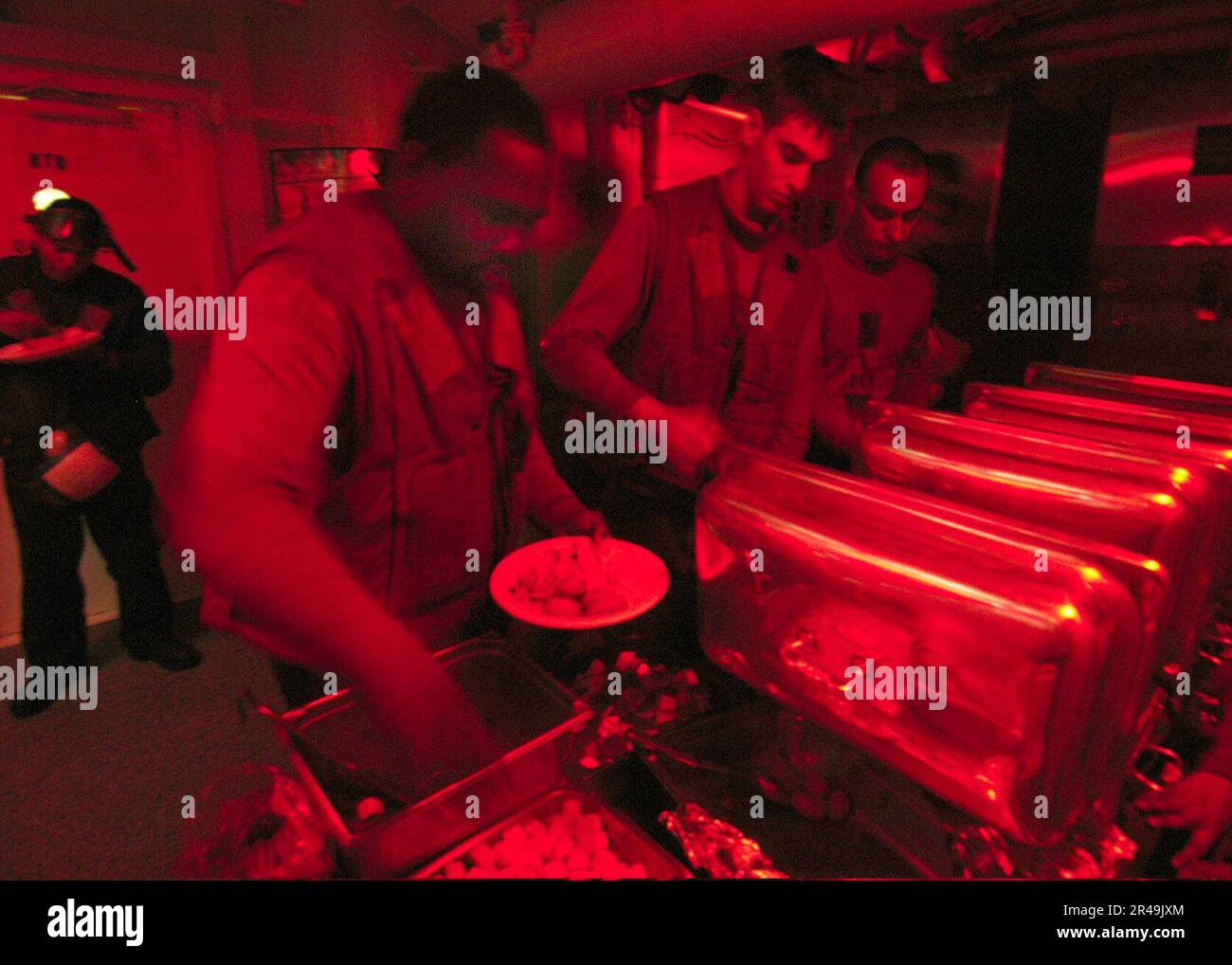 US Navy Flight deck personnel help themselves to a Thanksgiving dinner ...