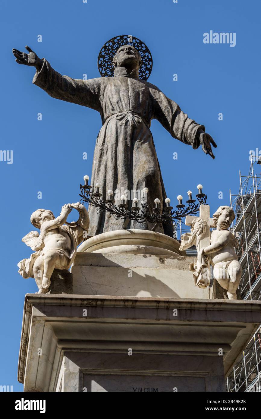 A vertical low angle shot of a historic religious statue in Naples ...