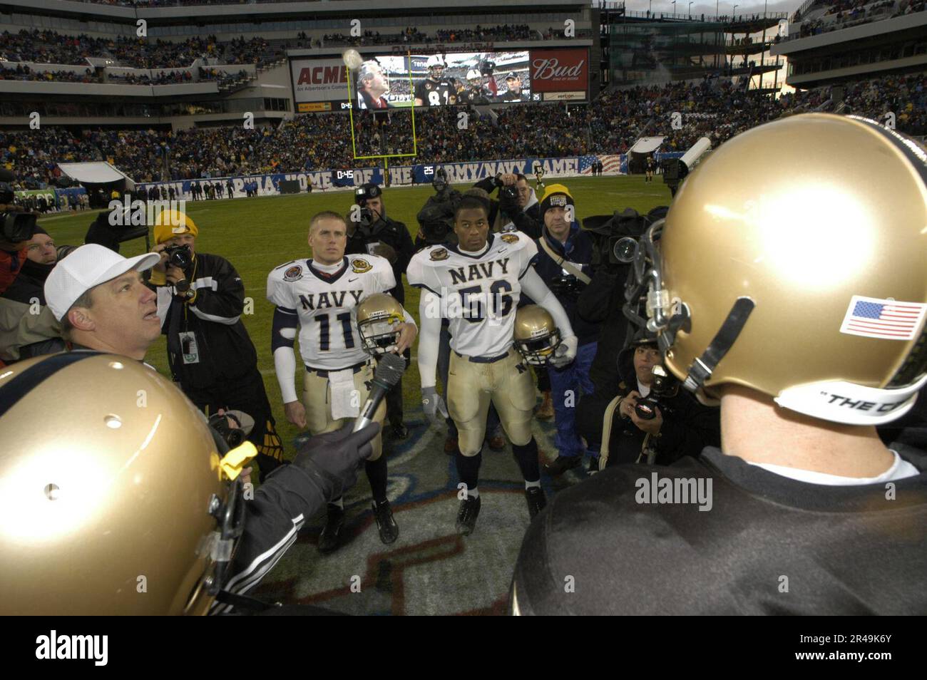 US Navy U.S. Naval Academy football team captains (11) and (56) watch ...