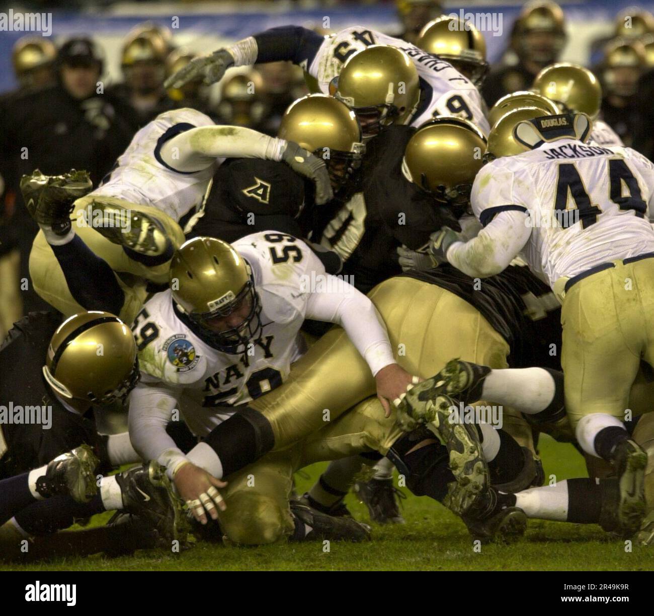 US Navy Army and Navy football players vie for control of the ball ...