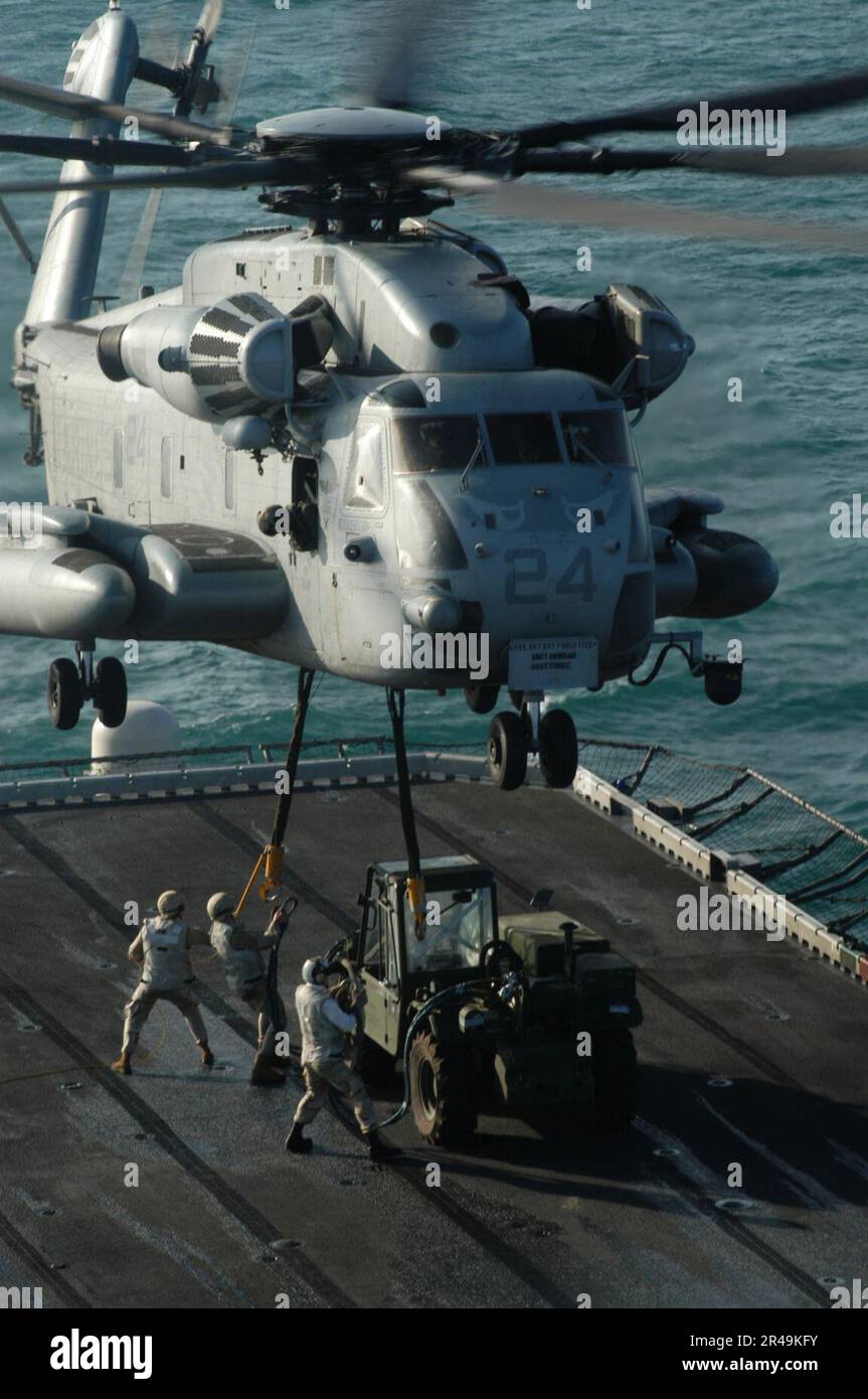 US Navy Combat Cargo crewmembers secure a forklift to a U.S. Marine ...