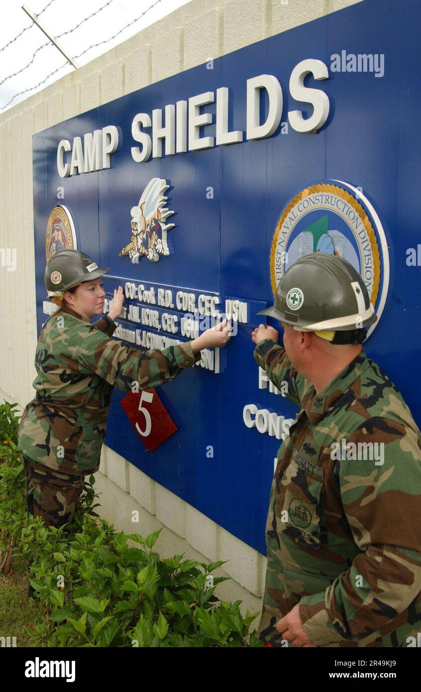 US Navy Builder 3rd Class and Utilitiesman 1st Class change the Camp ...