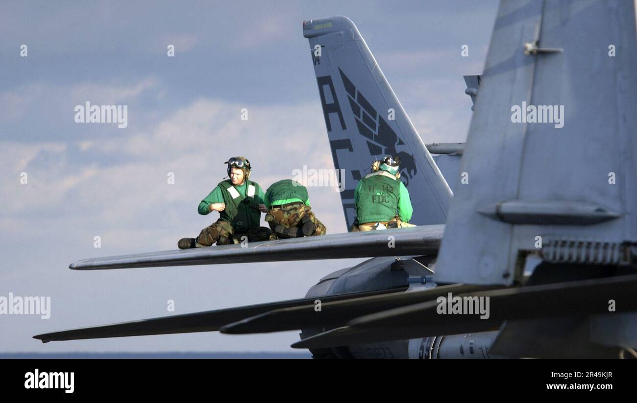 US Navy Three Crewmembers assigned to the Pukin' Dogs of Fighter ...