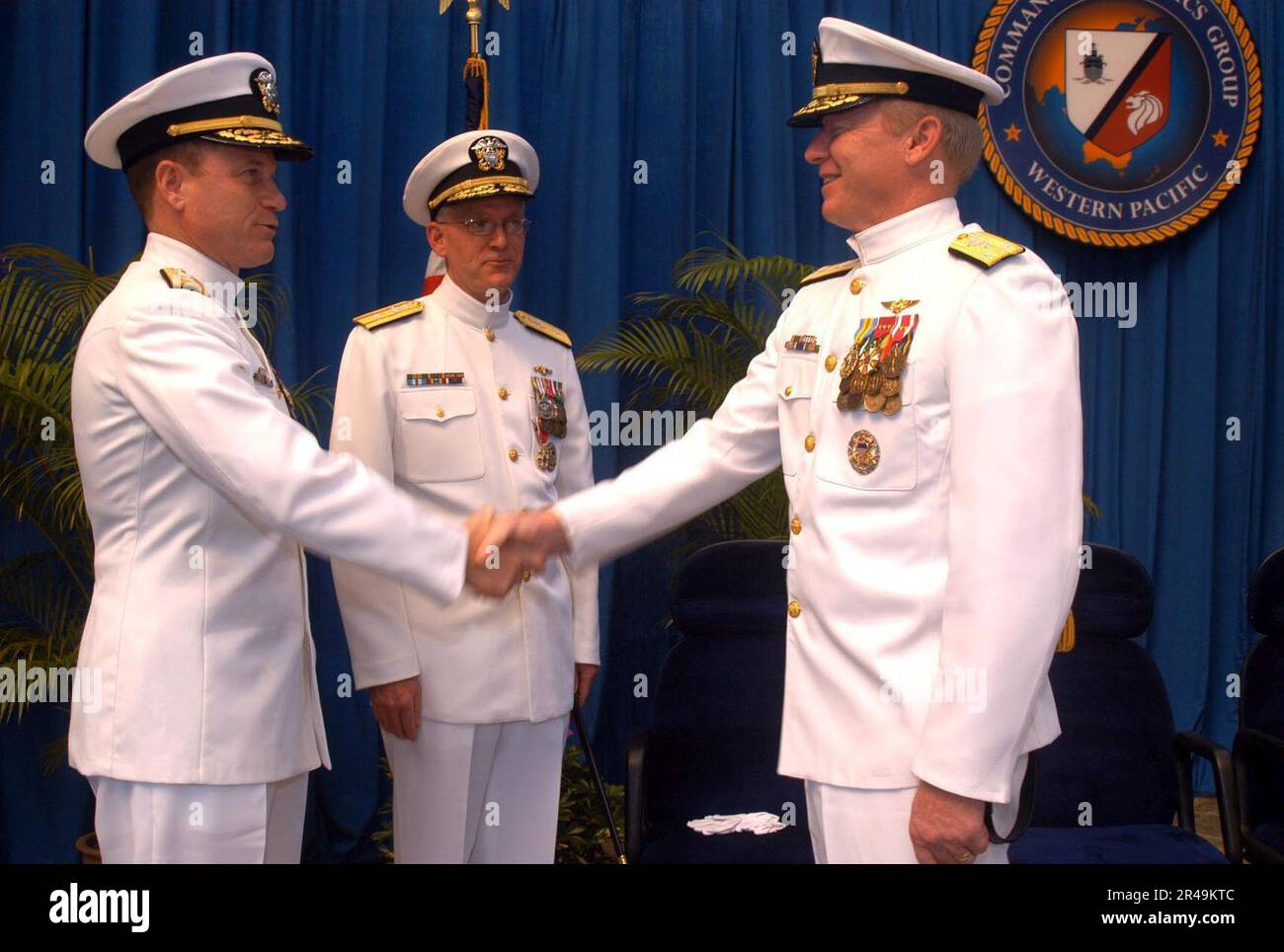 US Navy Rear Adm. Kevin M. Quinn (left) is congratulated by Seventh ...
