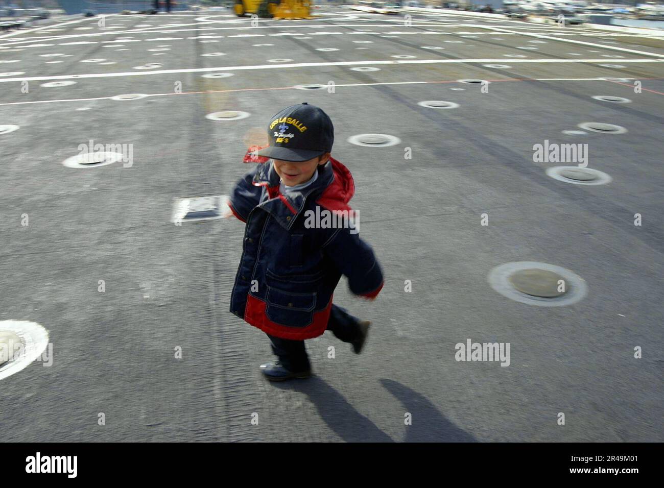 US Navy A small child has a little fun running around the flight deck aboard USS La Salle (AGF 3 ...