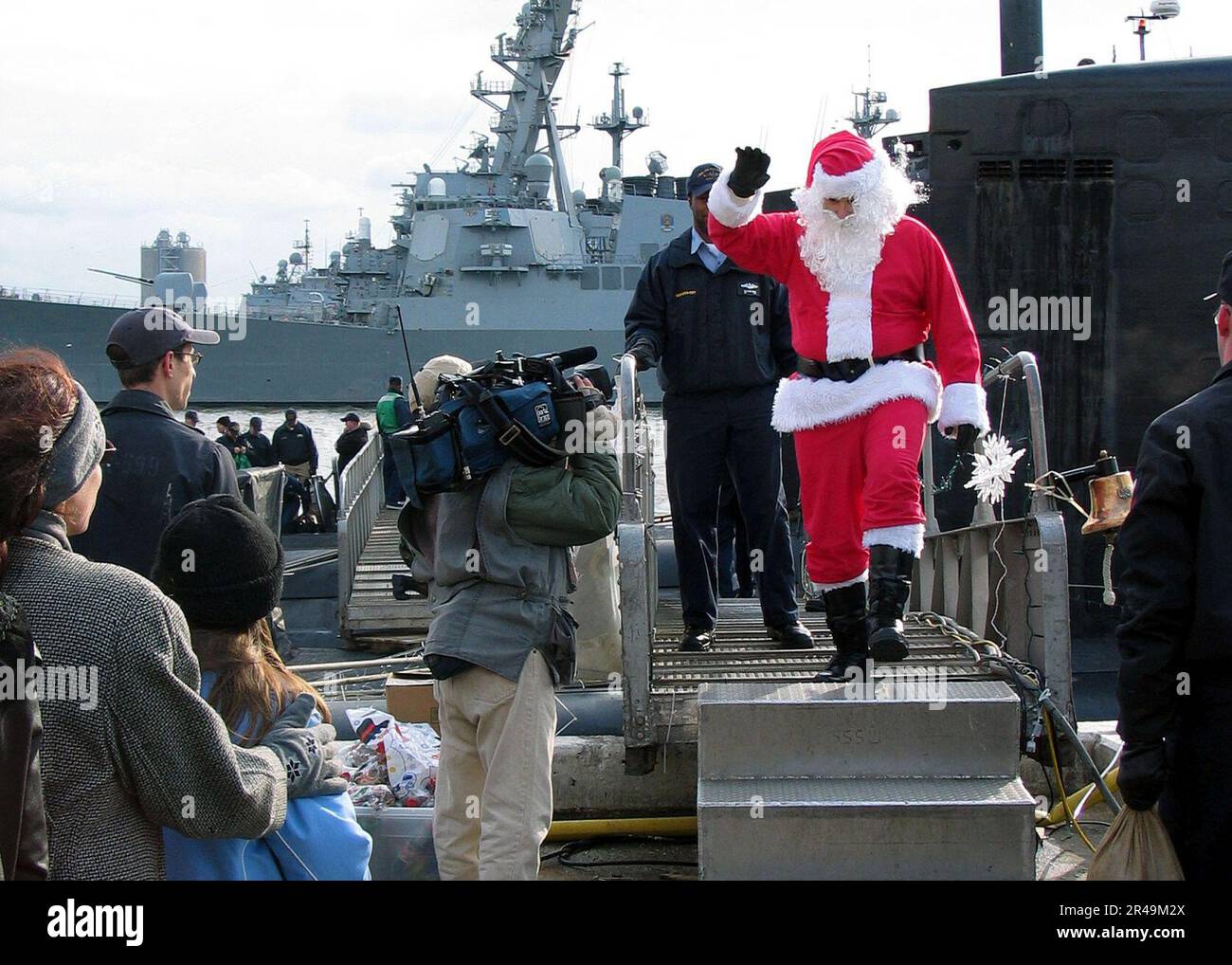 US Navy Santa Claus comes across the brow from the nuclear powered Los ...