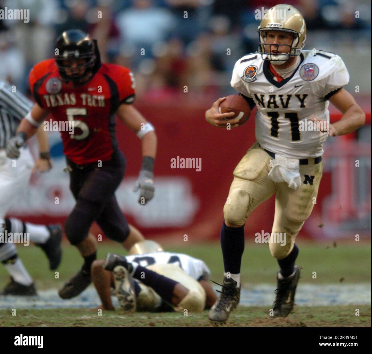 US Navy Navy quarterback heads upfield with Texas Tech linebacker in ...