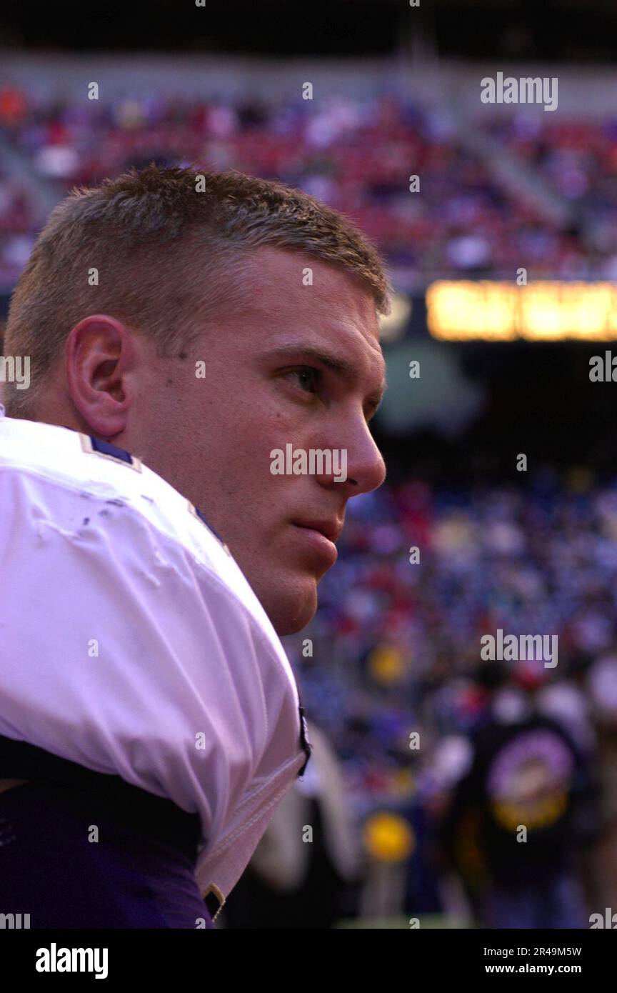US Navy Navy quarterback looks on from the bench as the Navy defense ...